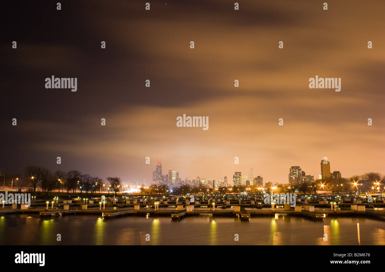 The skyline of Chicago, IL sparkles on a cold winter night as ice ...