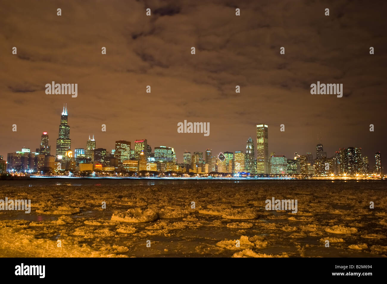 The skyline of Chicago, IL sparkles on a cold winter night as ice ...