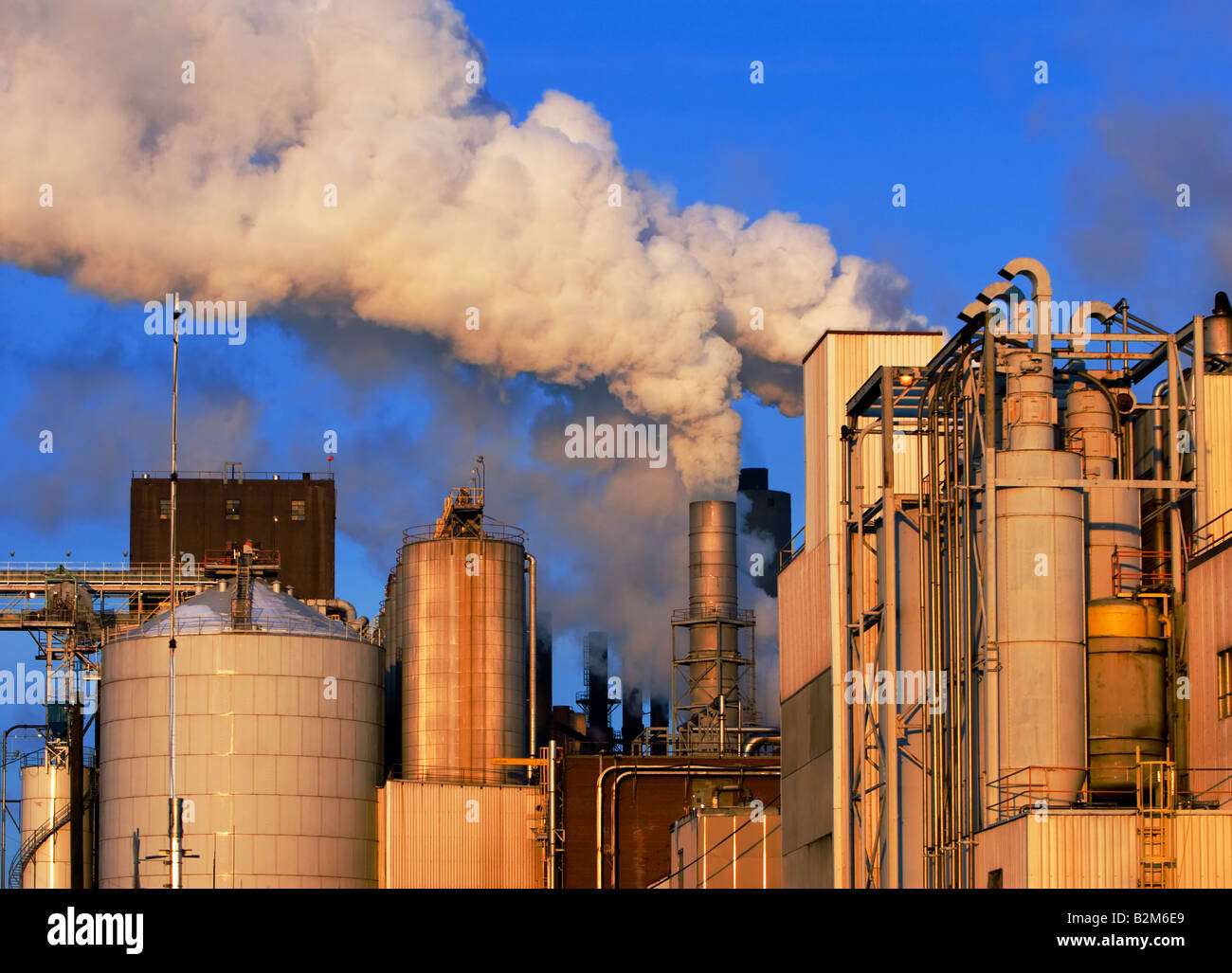 A factory emits smoke and steam on a cold winter day in Iowa Stock ...