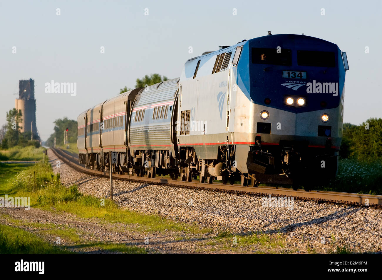 An Amtrak train speeds down the tracks in rural Illinois Stock Photo ...