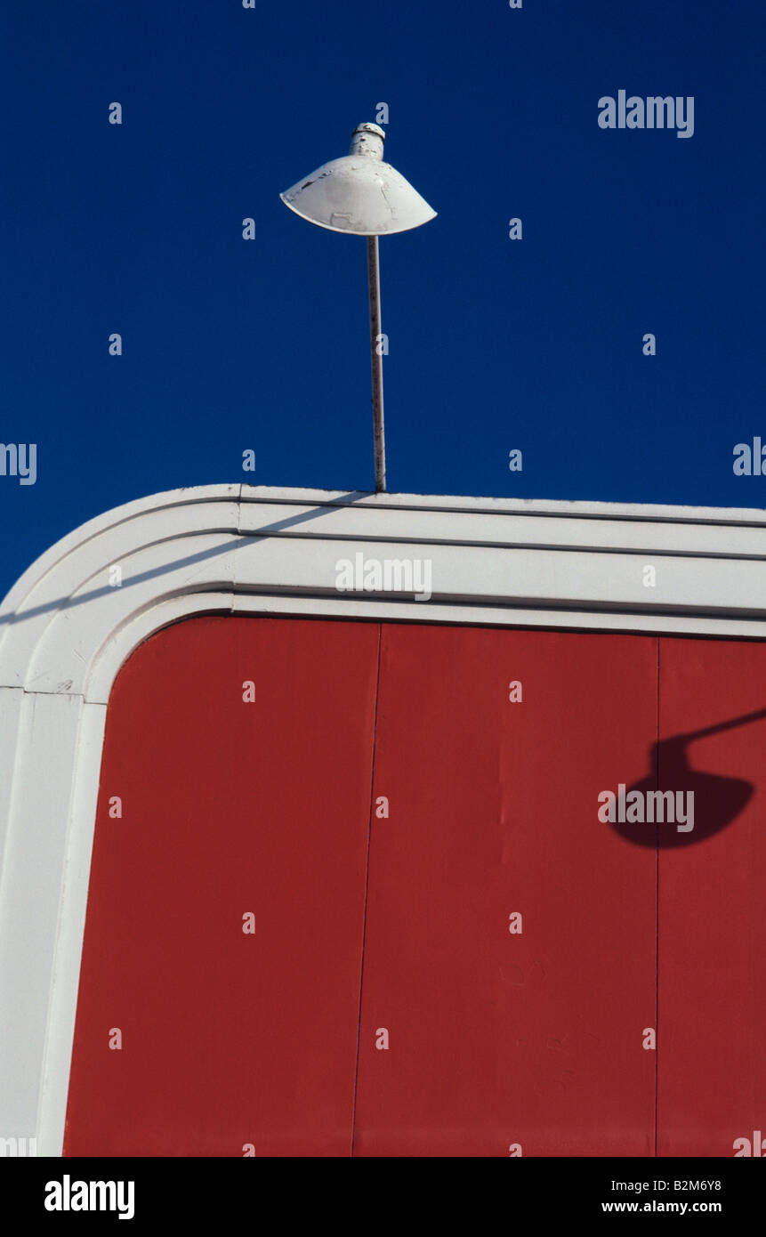 White street lamp over a red billboard with blue skies downtown Seattle ...