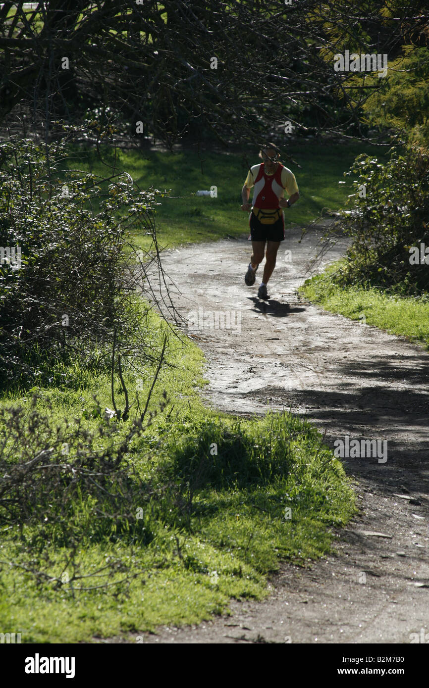 one runner on footpath in park Stock Photo - Alamy