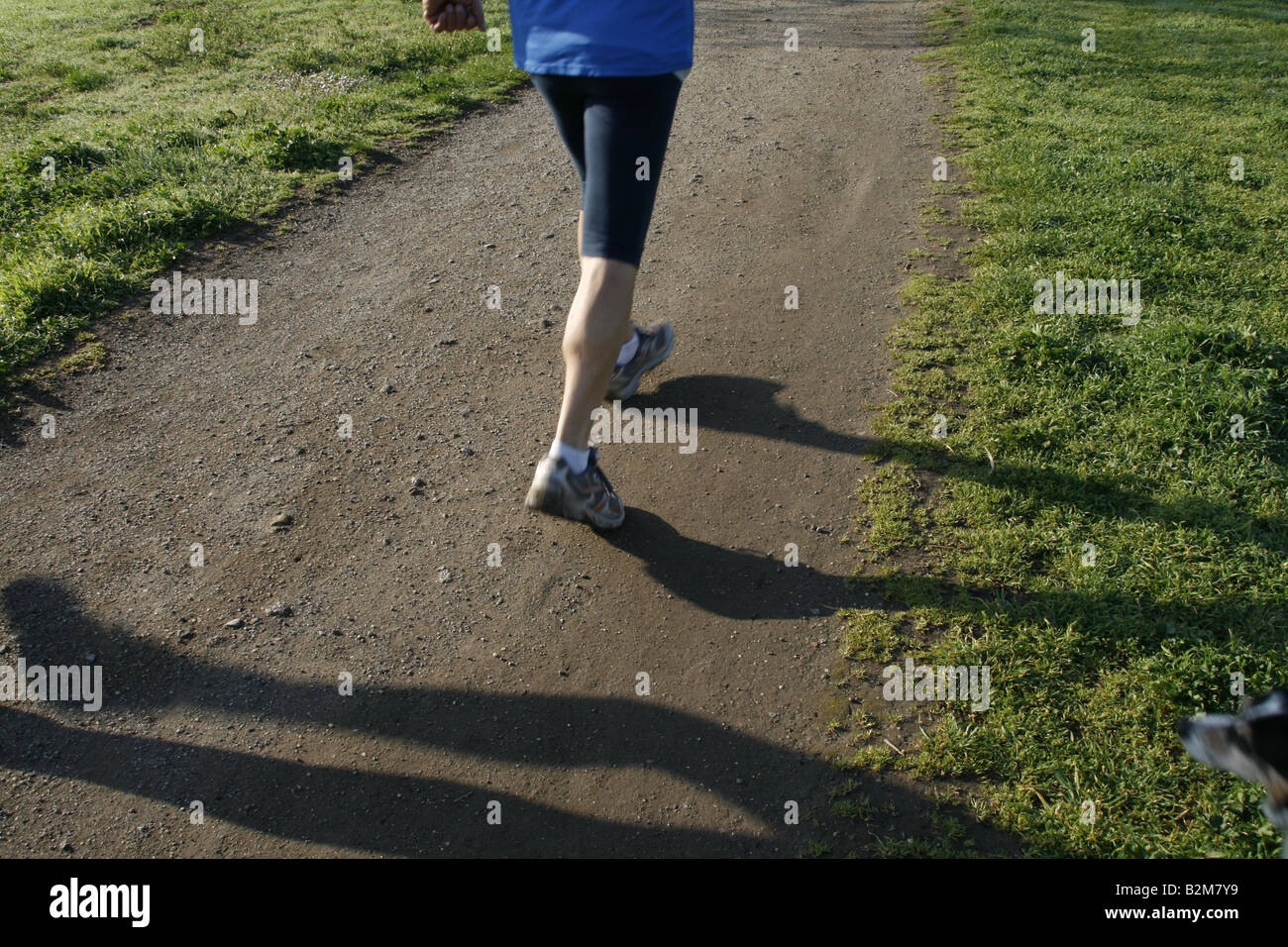 one single woman jogging on path in park Stock Photo - Alamy