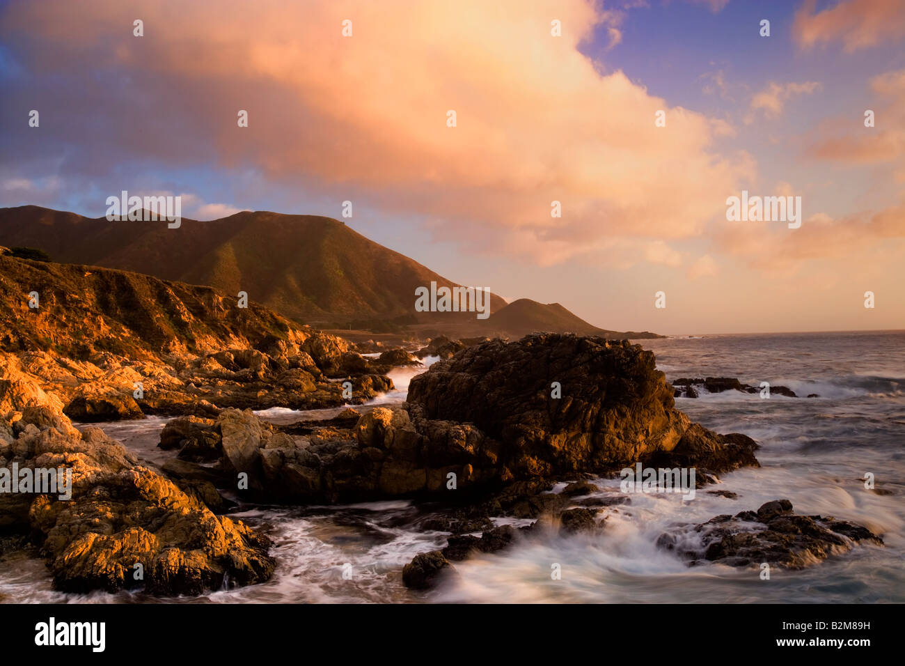 Sunset warms the landscape and clouds at Garrapata State Beach along ...