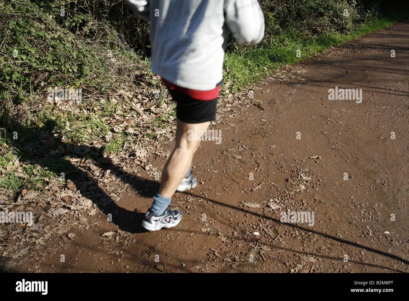 one man runner on rural country path in park Stock Photo - Alamy