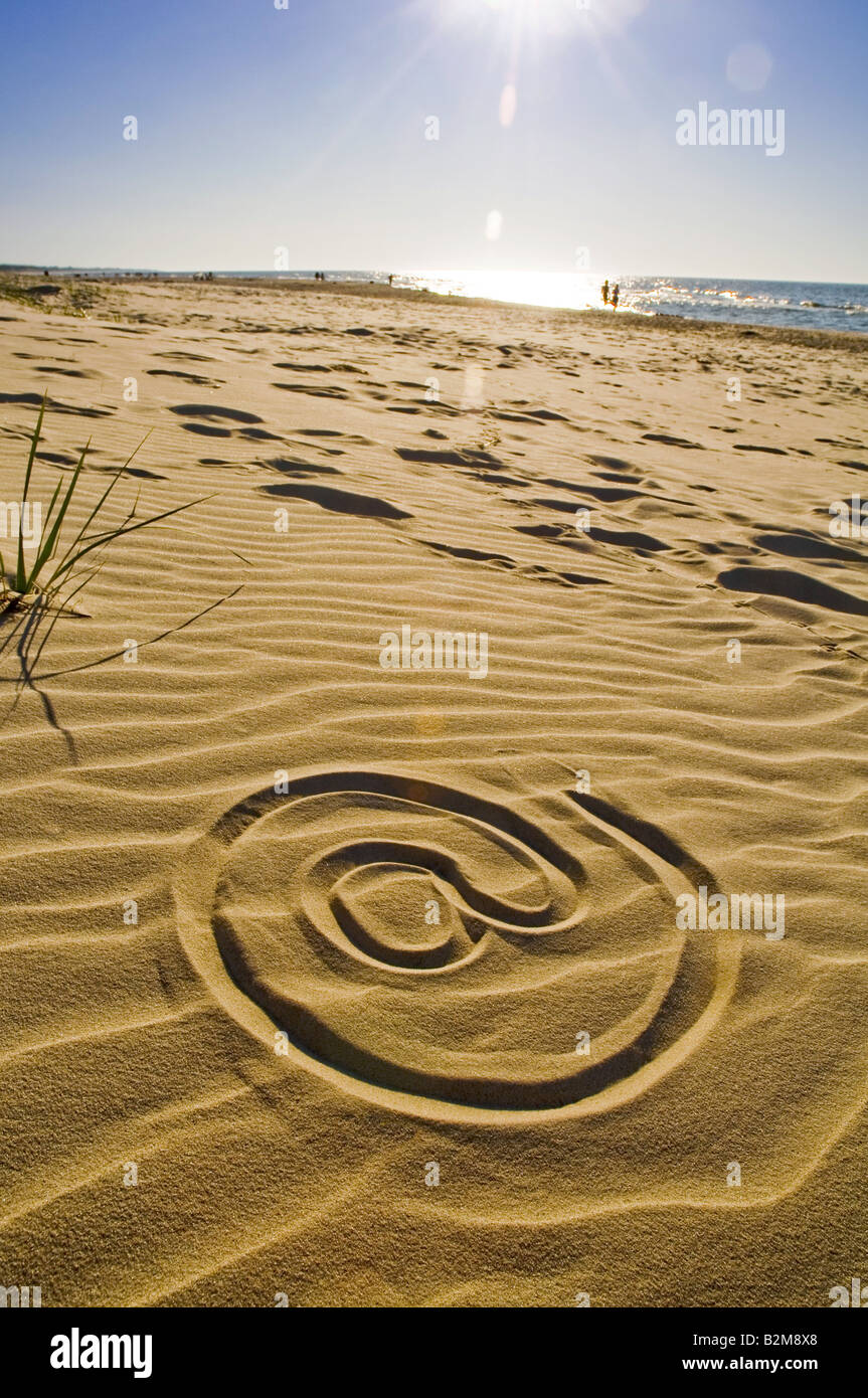 At sign drawn in the sand on the beach Stock Photo - Alamy