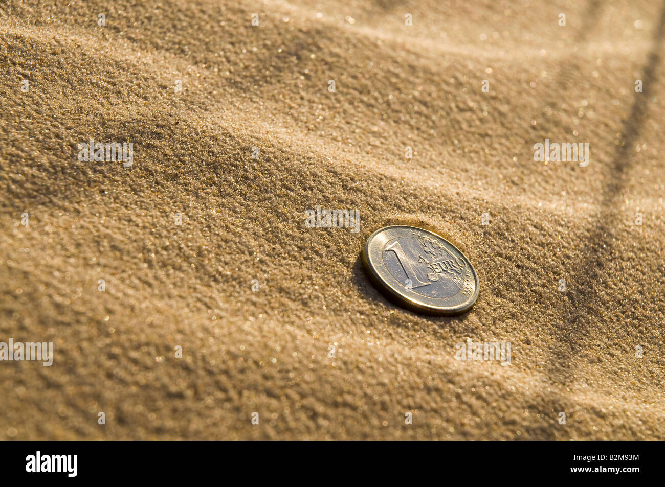 Euro coin lying on the beach Stock Photo - Alamy