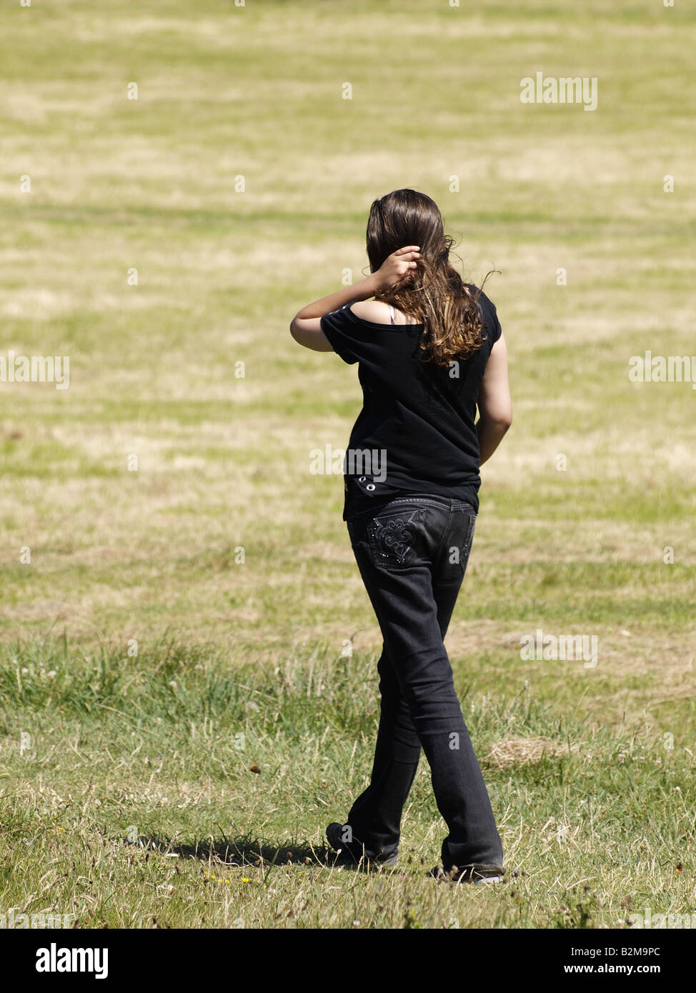 Teenage girl running her hand through her hair Stock Photo - Alamy