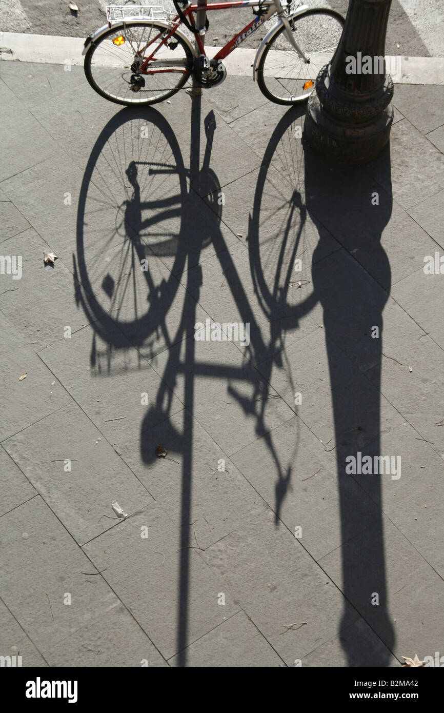 one bike shadow on sidewalk road in sun Stock Photo - Alamy