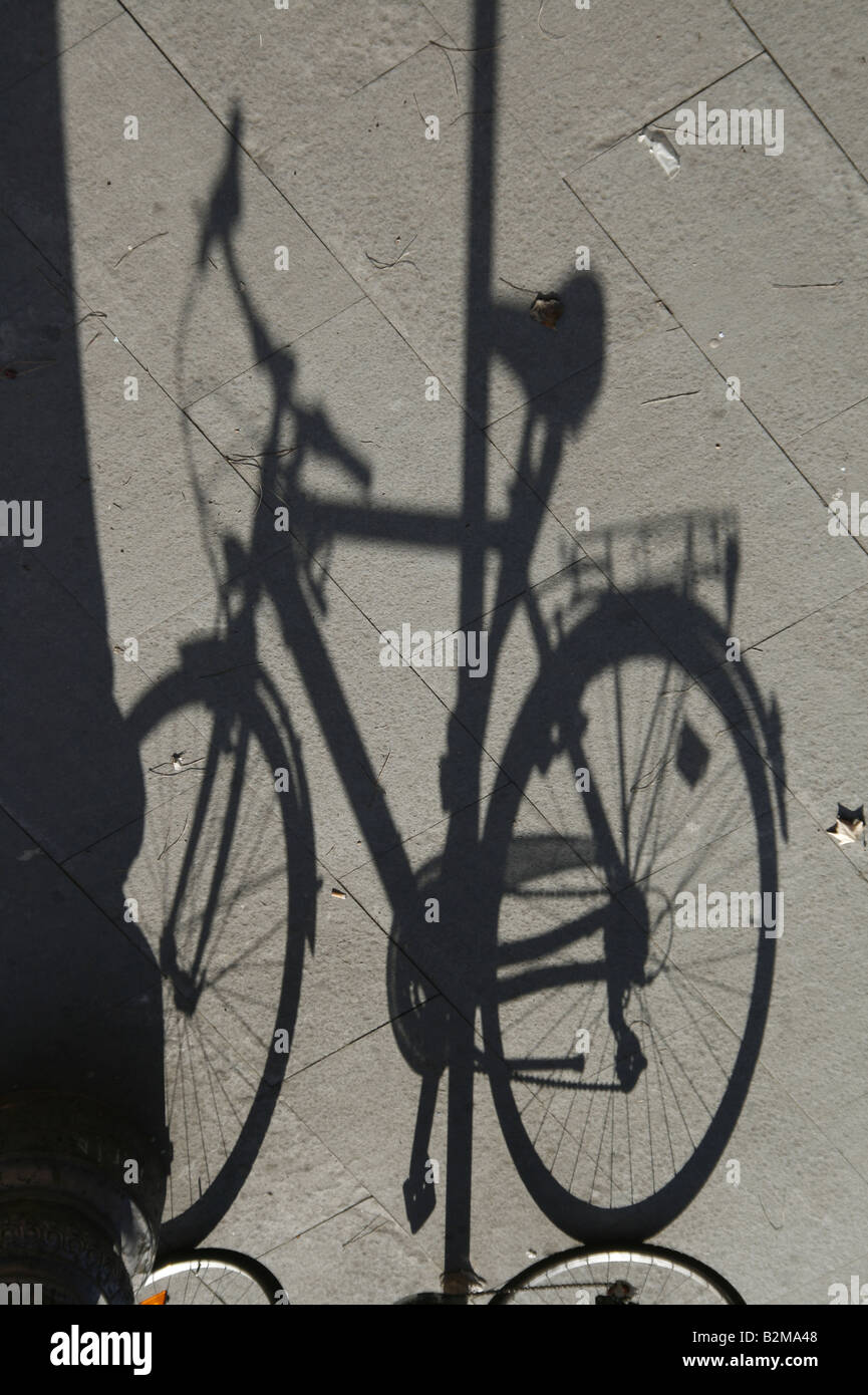 one bike shadow on sidewalk road in sun Stock Photo - Alamy