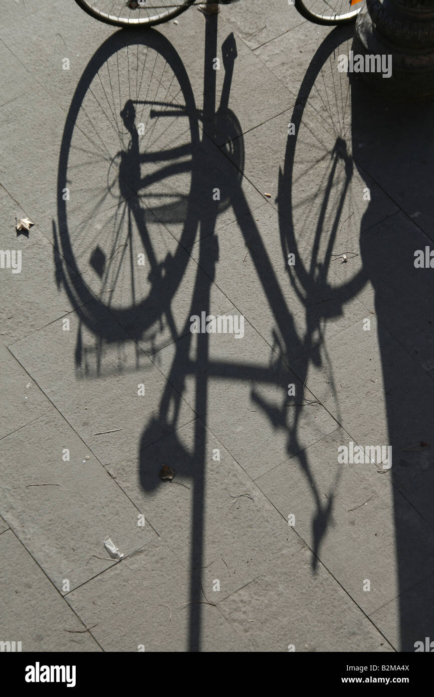 one bike shadow on sidewalk road in sun Stock Photo - Alamy