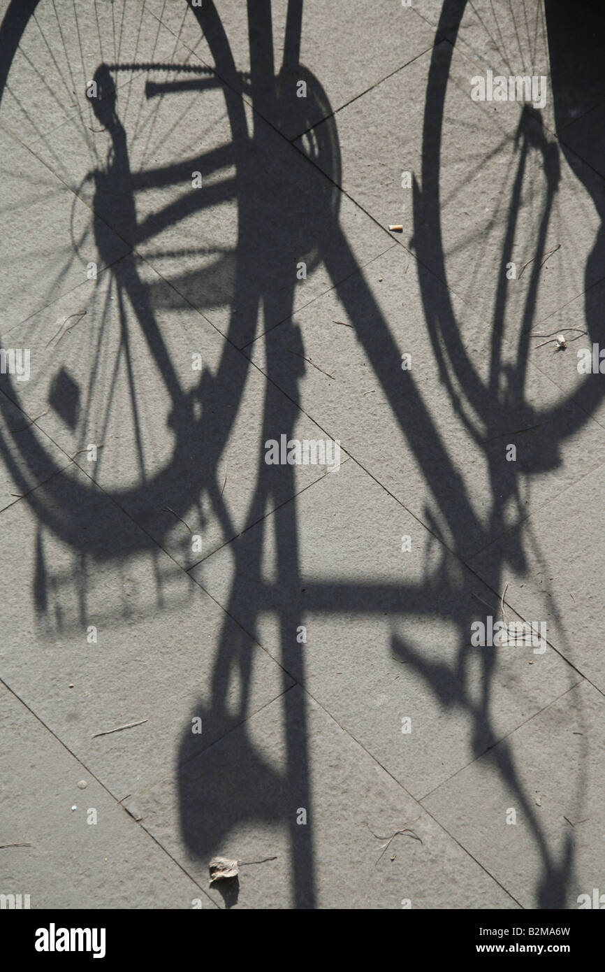 one bike shadow on sidewalk road in sun Stock Photo - Alamy