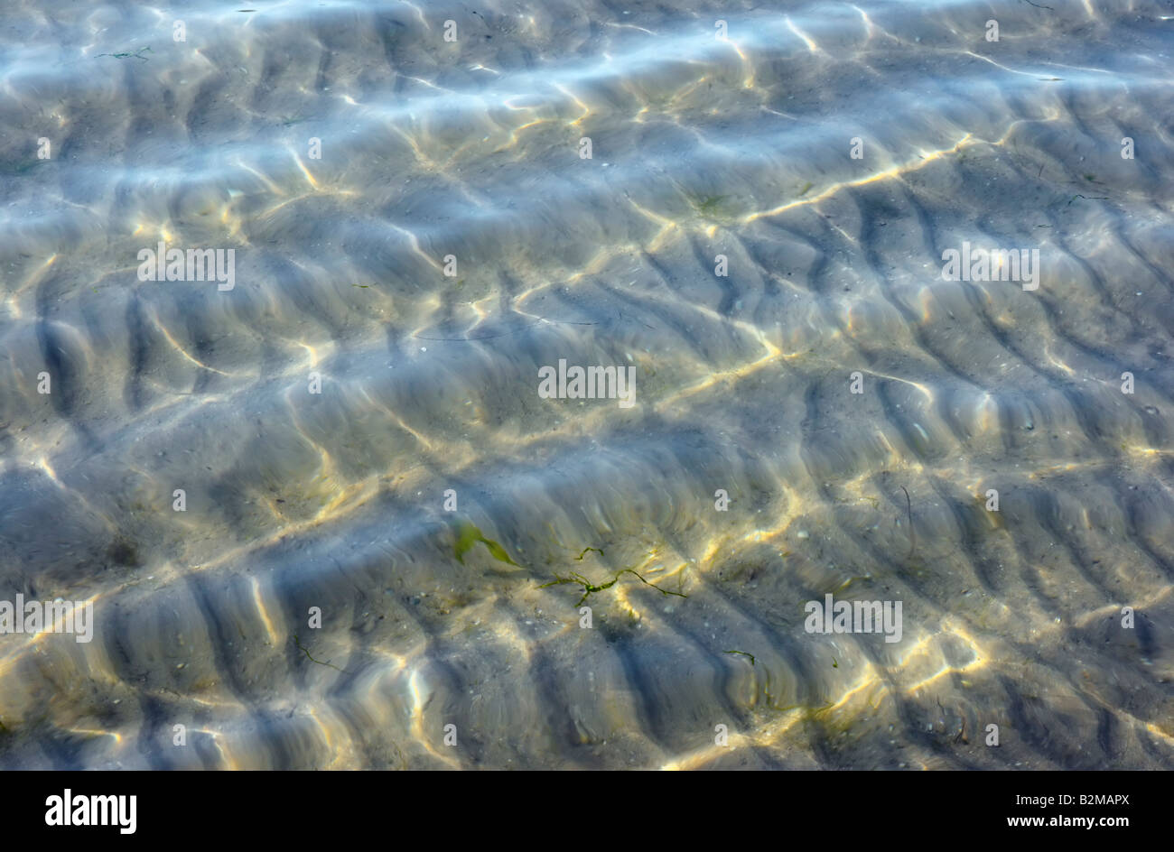 Sandy sea bottom in through water and waves on surface Stock Photo - Alamy