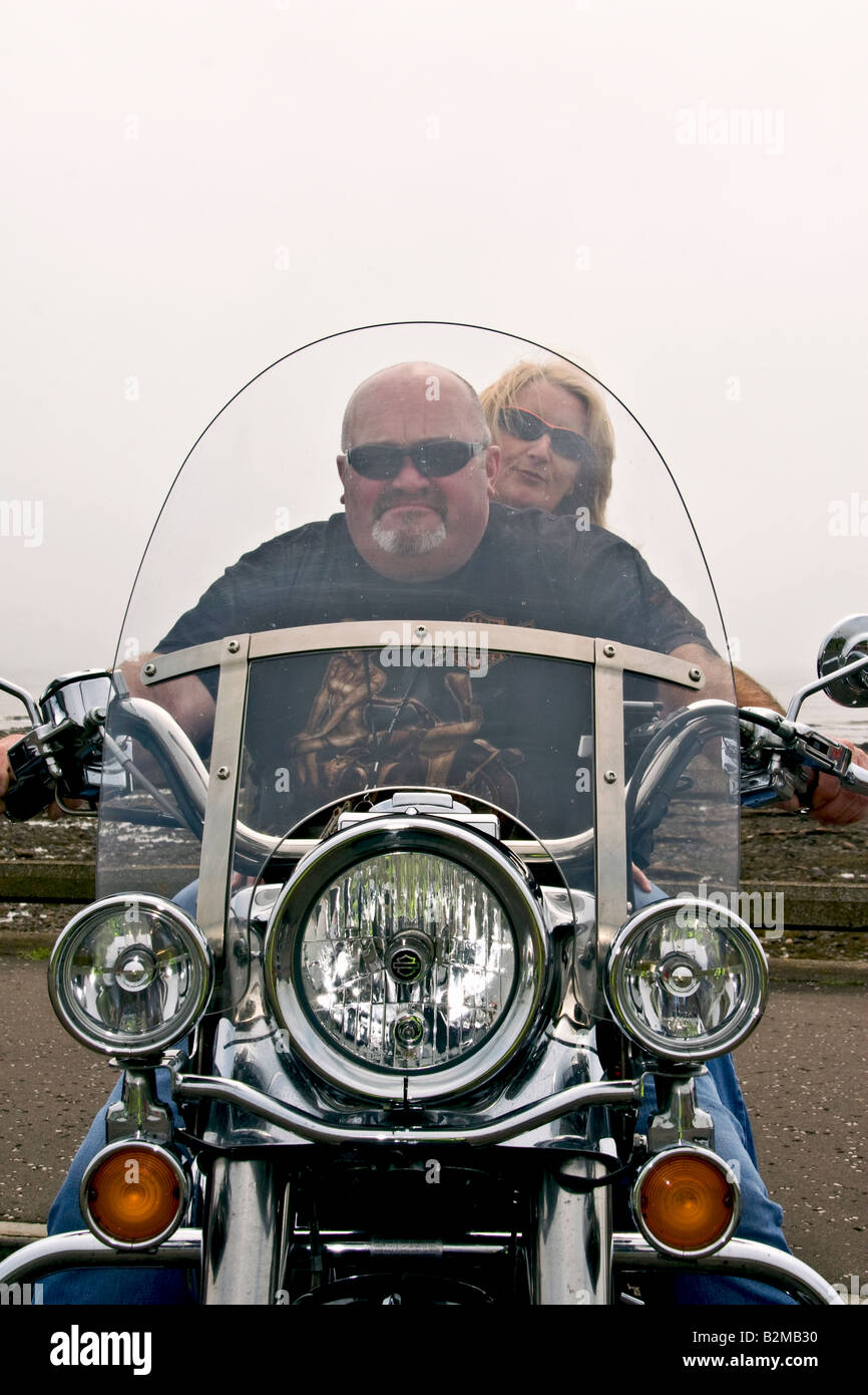 Two bikers sitting on their Harley Davidson motorbike at the Seafare ...
