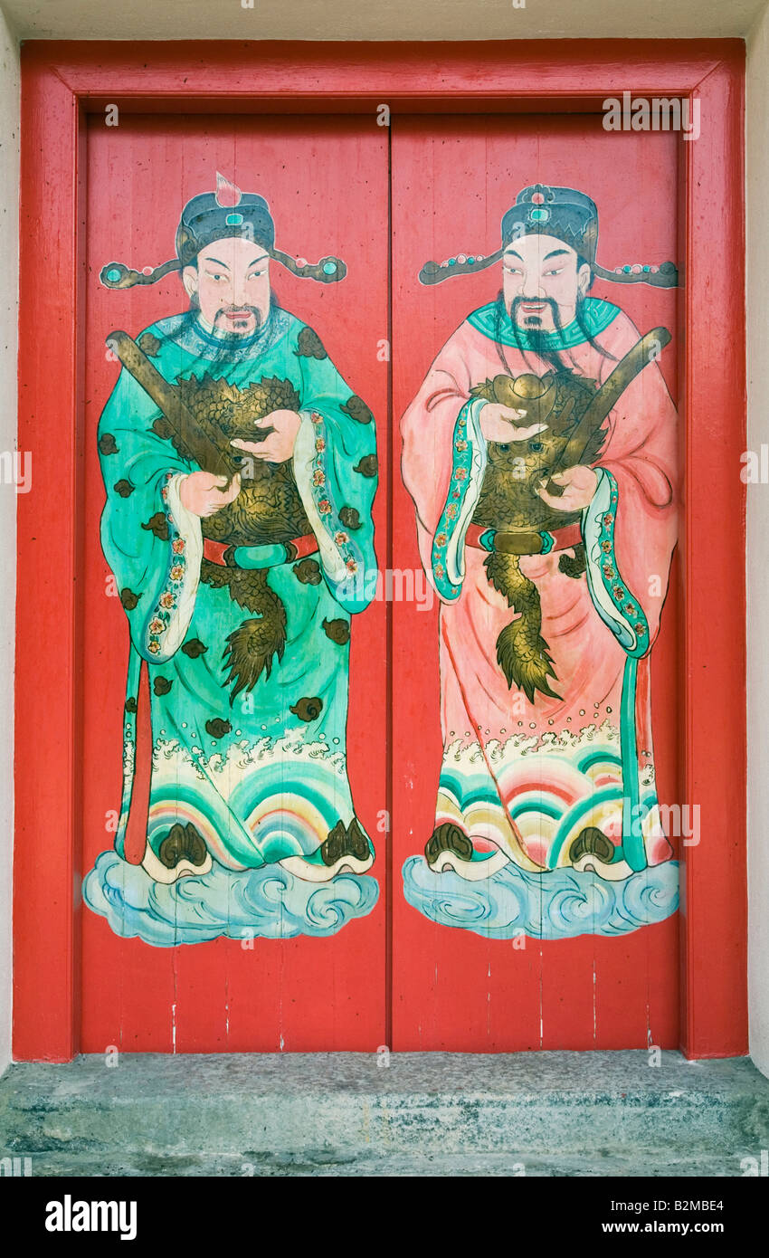 Double red wooden doors with artistic god figures at the ancestral ...