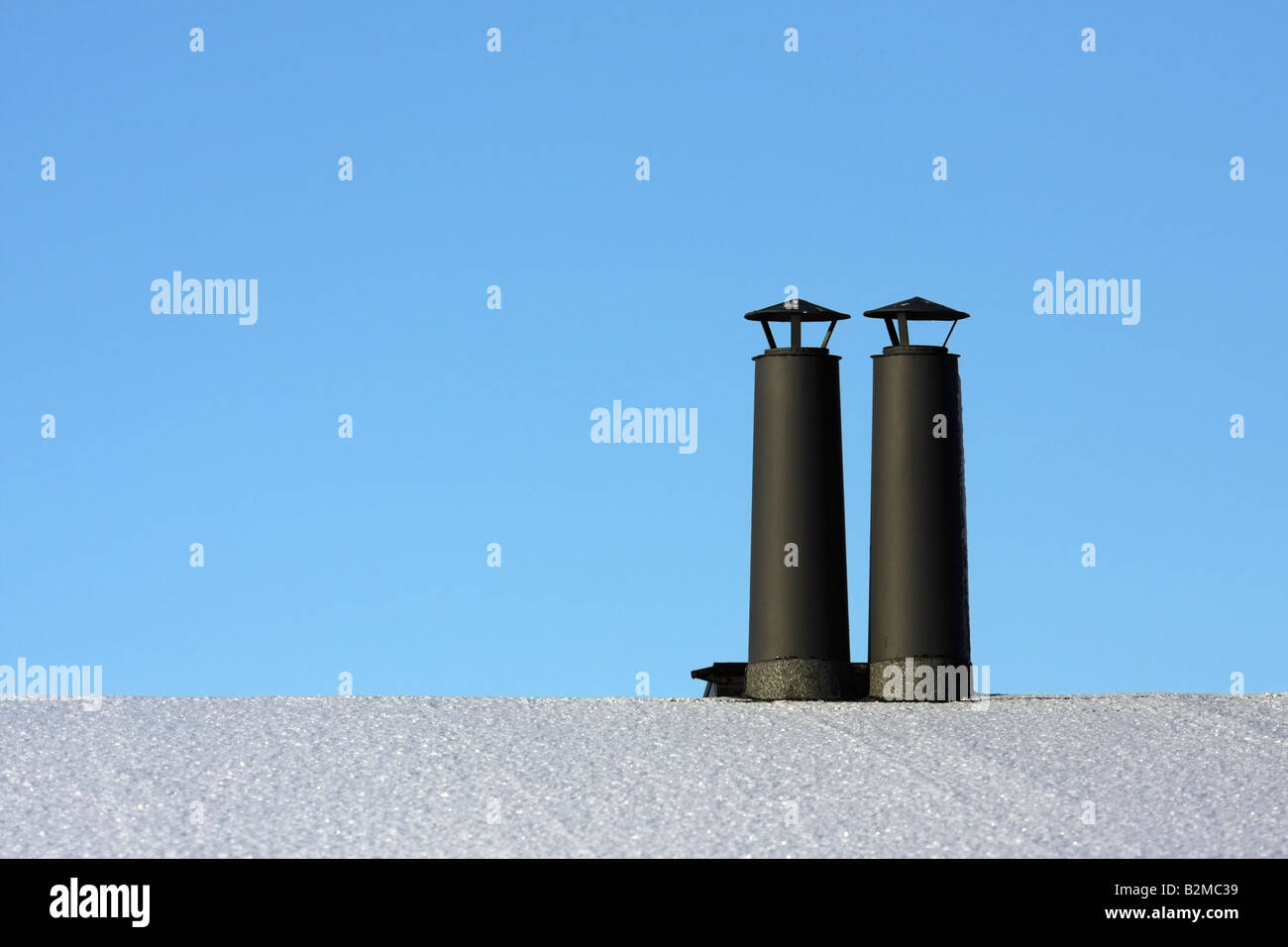 Two chimneys on a roof Stock Photo - Alamy