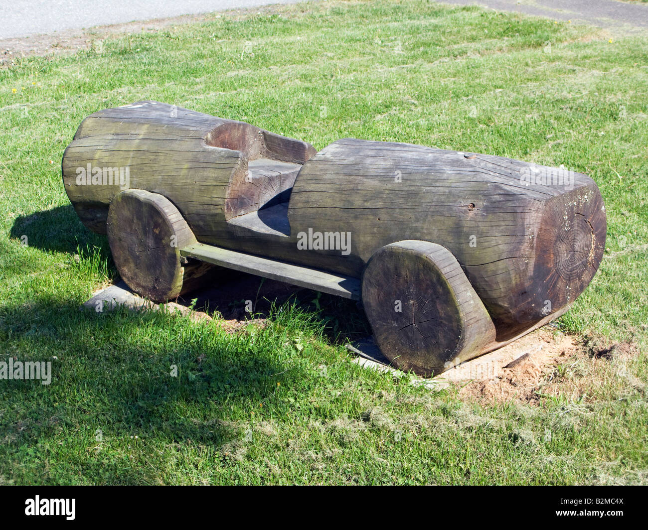A wooden log shaped as a car Stock Photo - Alamy