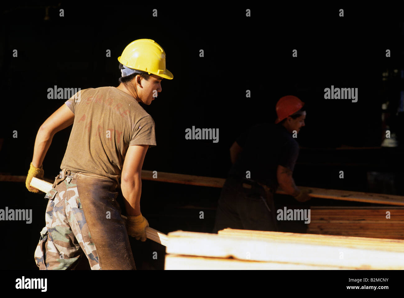 Lumber yard with male workers sorting wood planks near Darrington ...