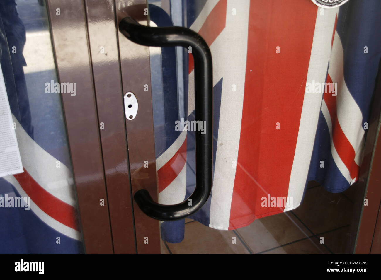 union jack british flag hanging in shop door Stock Photo - Alamy