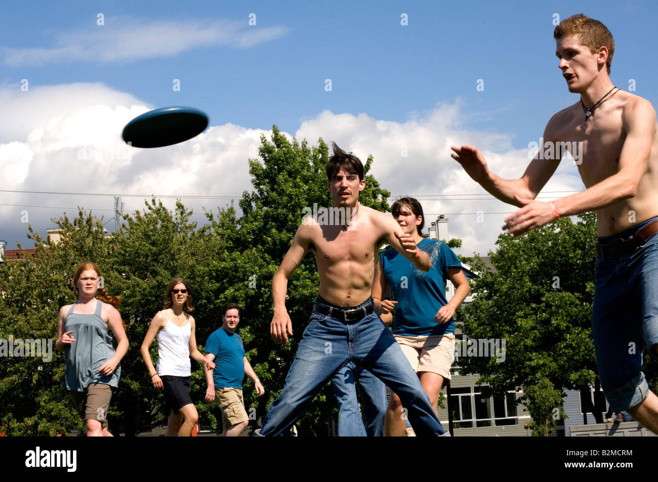 Group of people playing Frisbee in the park Stock Photo - Alamy