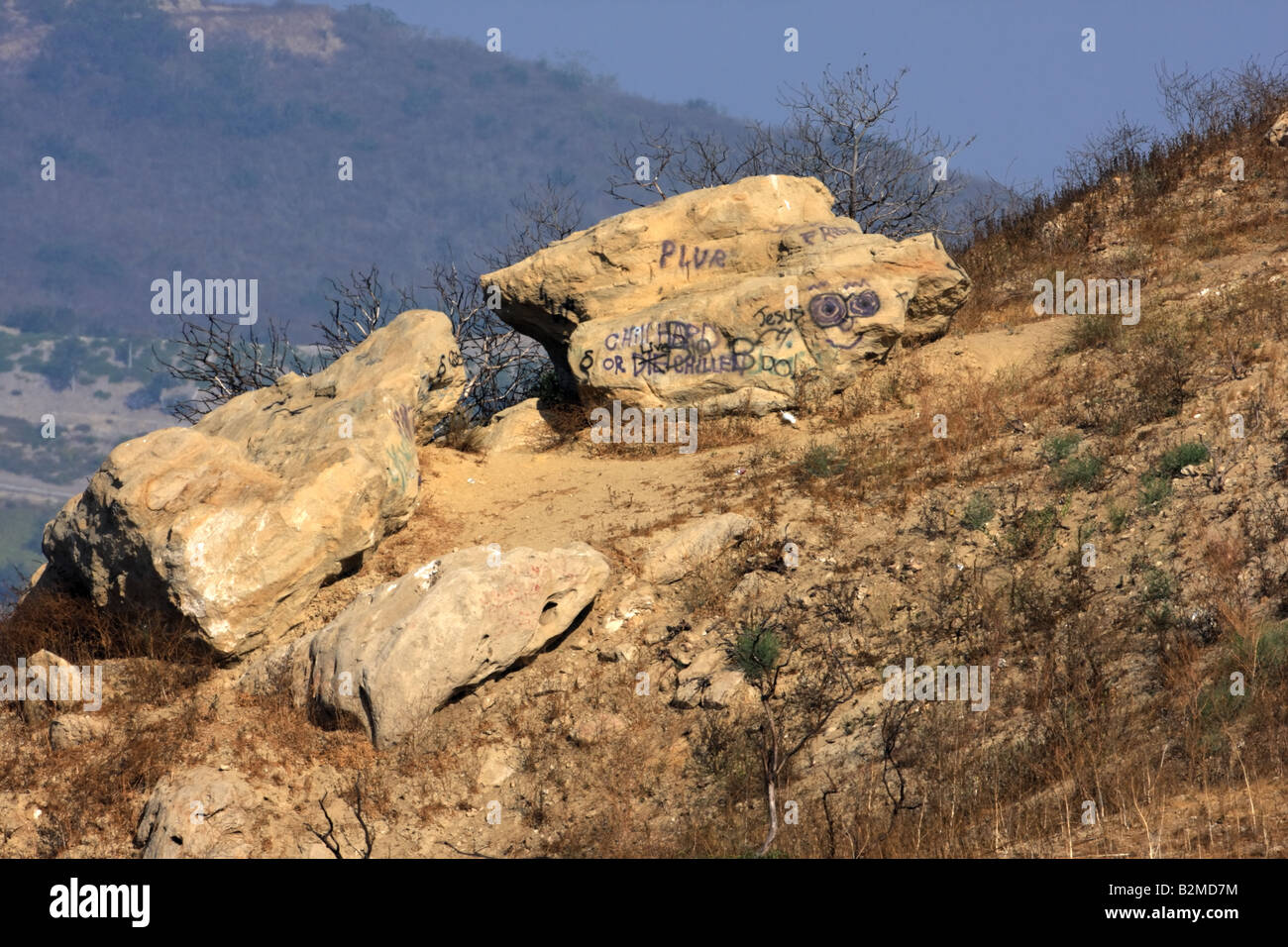 Grafitti on large rocks in wilderness Stock Photo - Alamy