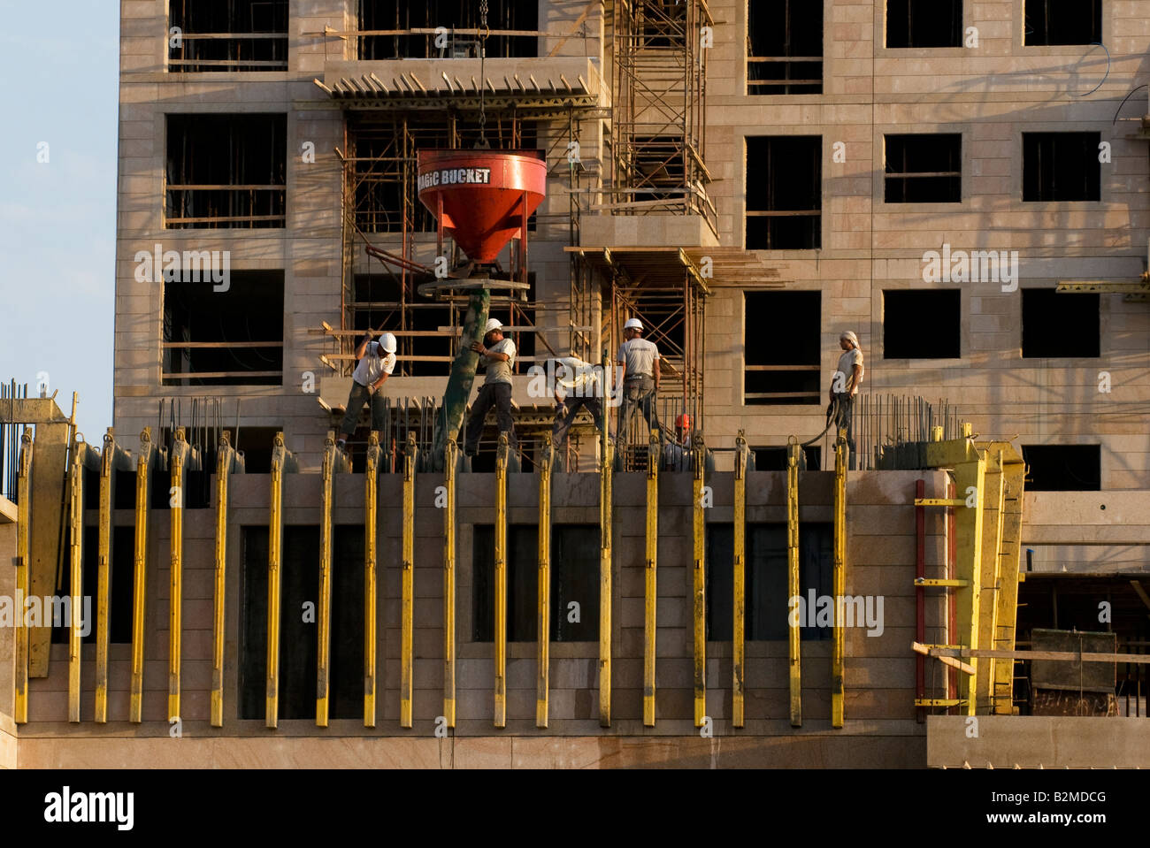 Construction crew casting concrete for the floor of a new apartment ...