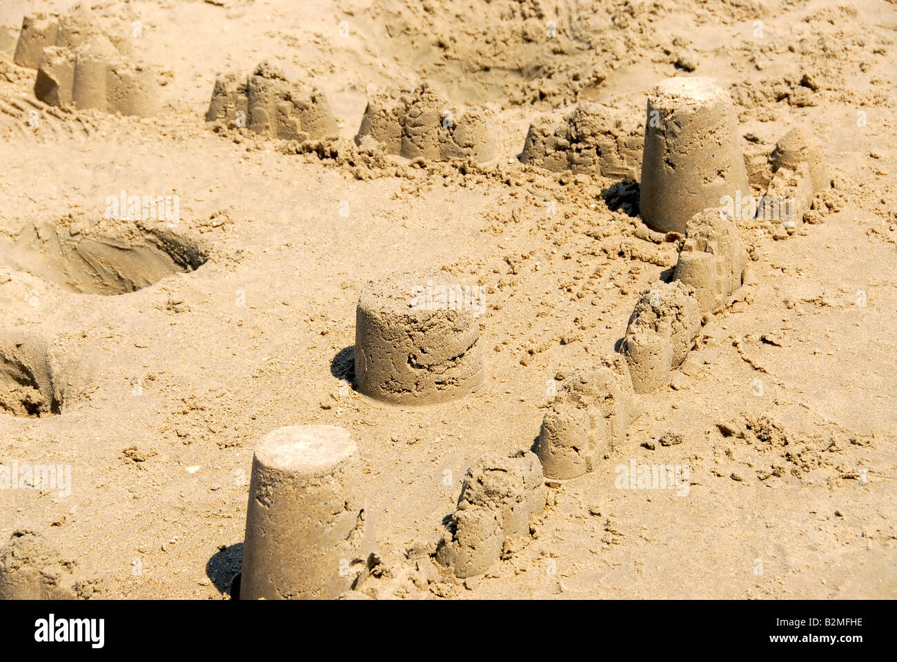 Sand castle with towers and walls on a beach Stock Photo - Alamy