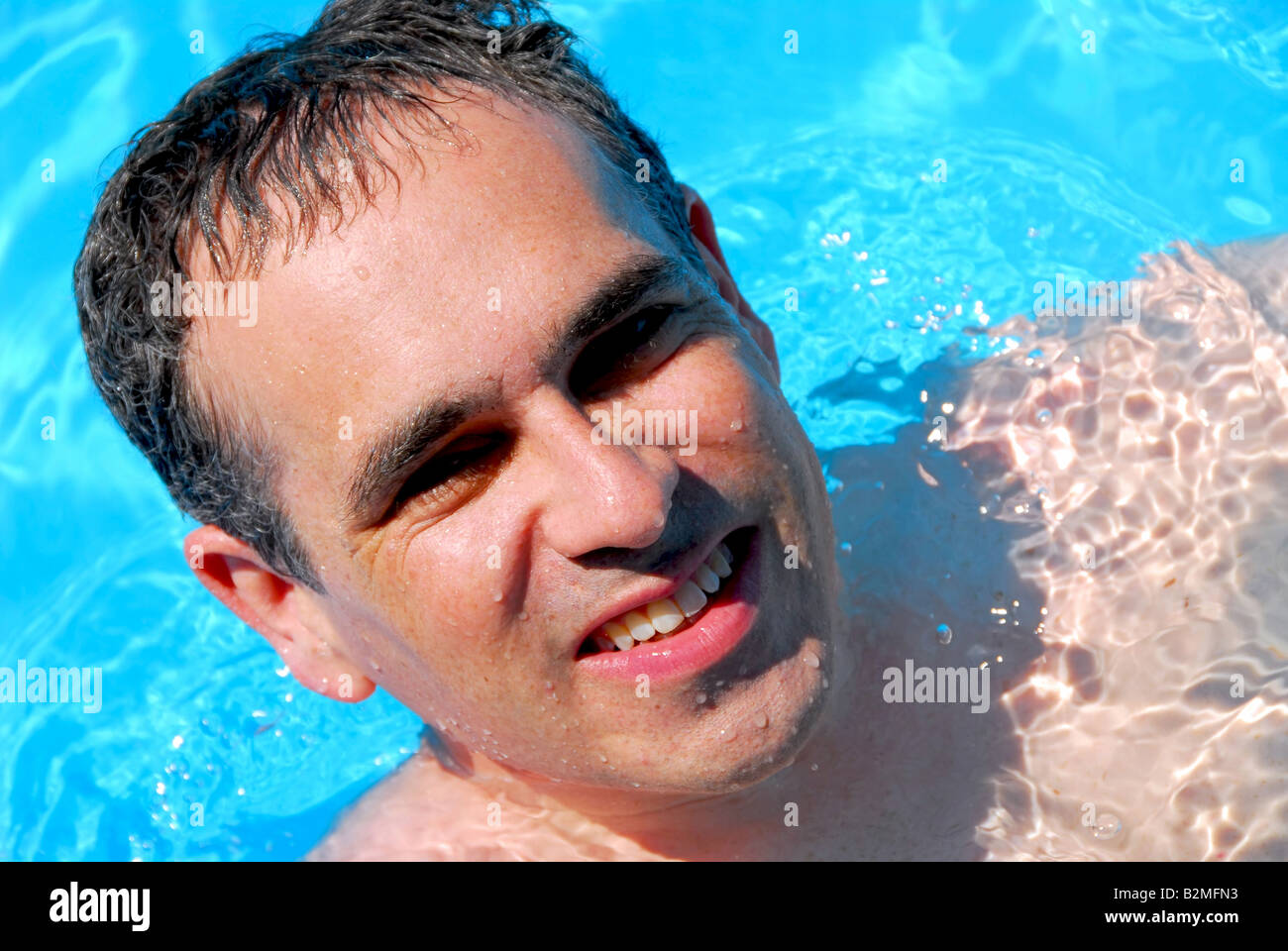 Portrait of a happy man in a swimming pool Stock Photo - Alamy