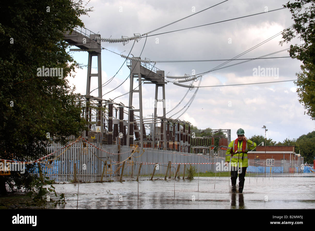 A POWER ENGINEER WADES THROUGH FLOODWATER AT THE WALHAM ELECTRICITY ...