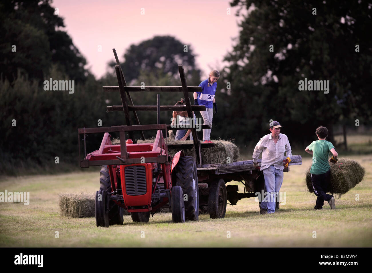 A FARMING FAMILY COLLECTING HAY IN THE TRADITIONAL STYLE IN ...