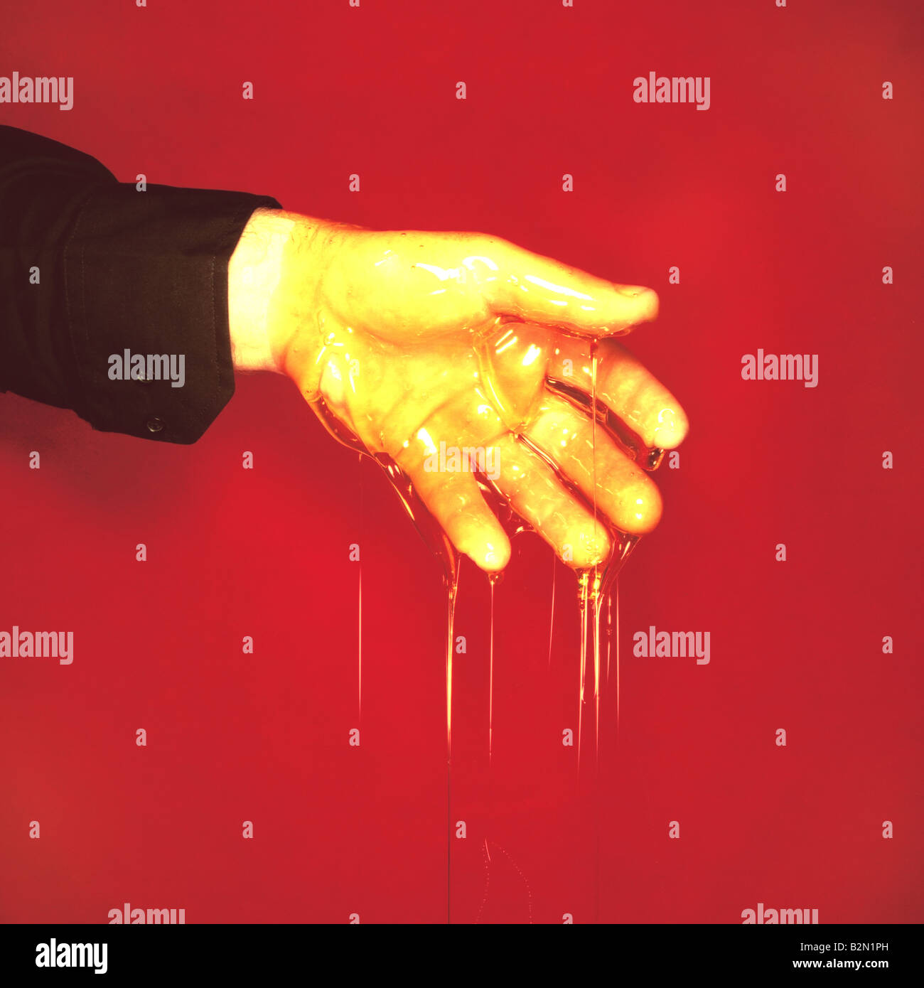 hand dripping with honey Stock Photo - Alamy