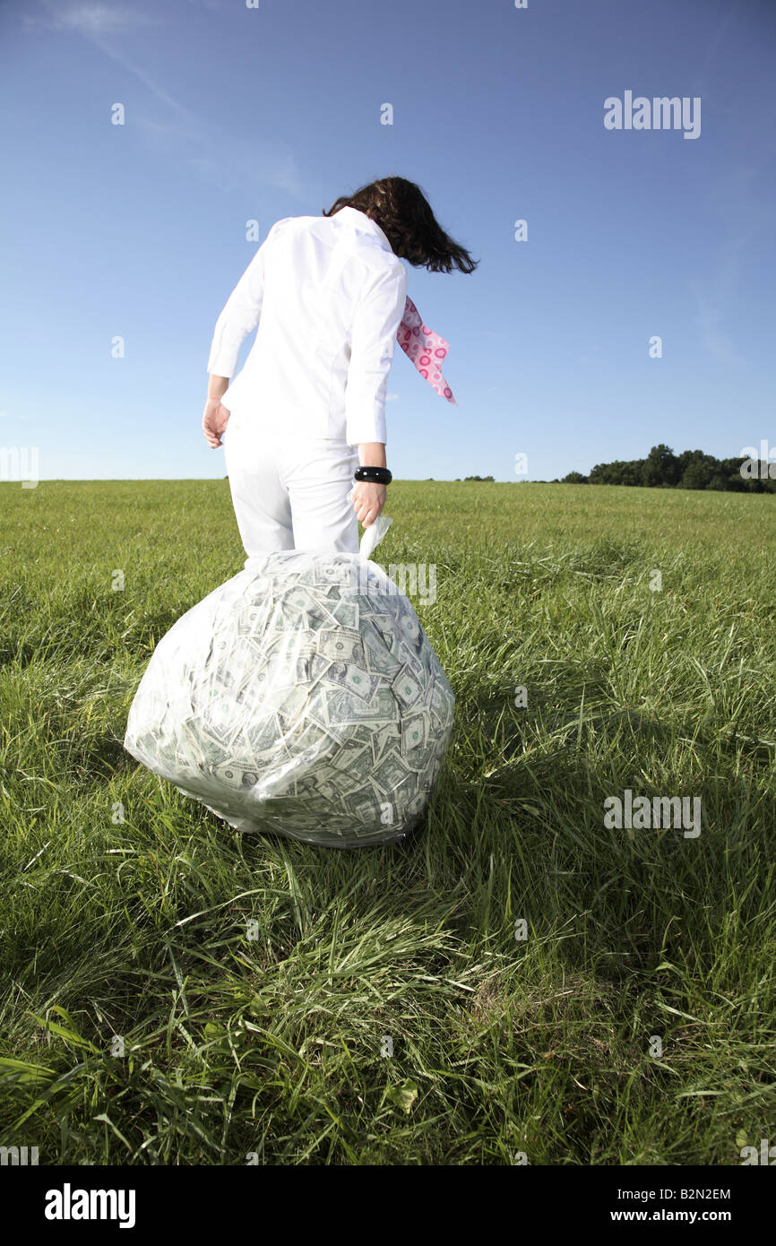 woman dragging bag of money Stock Photo - Alamy