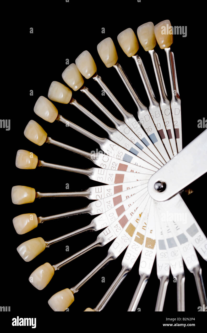 hand holding human teeth models isolated on black Stock Photo - Alamy