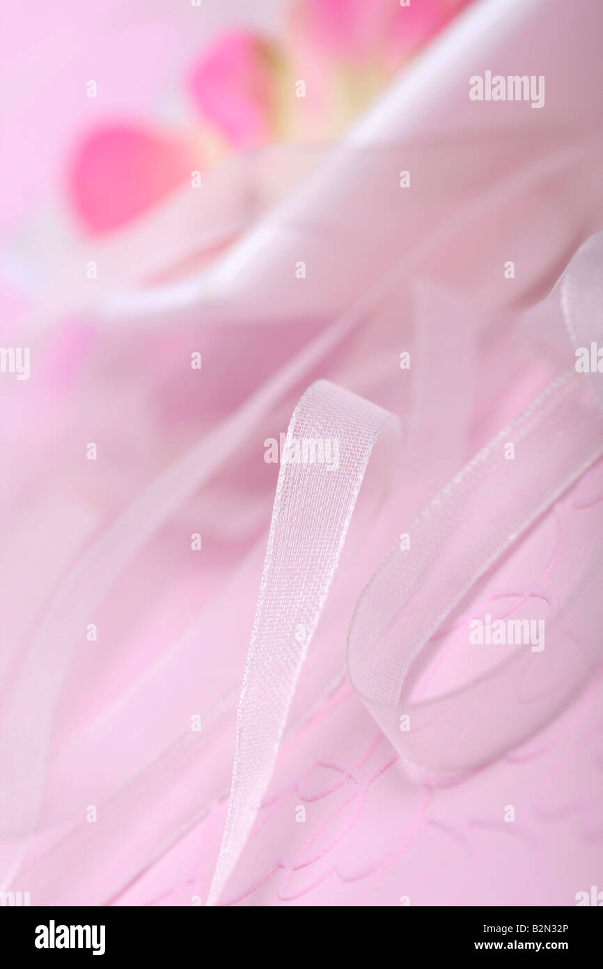 scented rose petal water in a bowl decorated with layers of lace ribbon ...