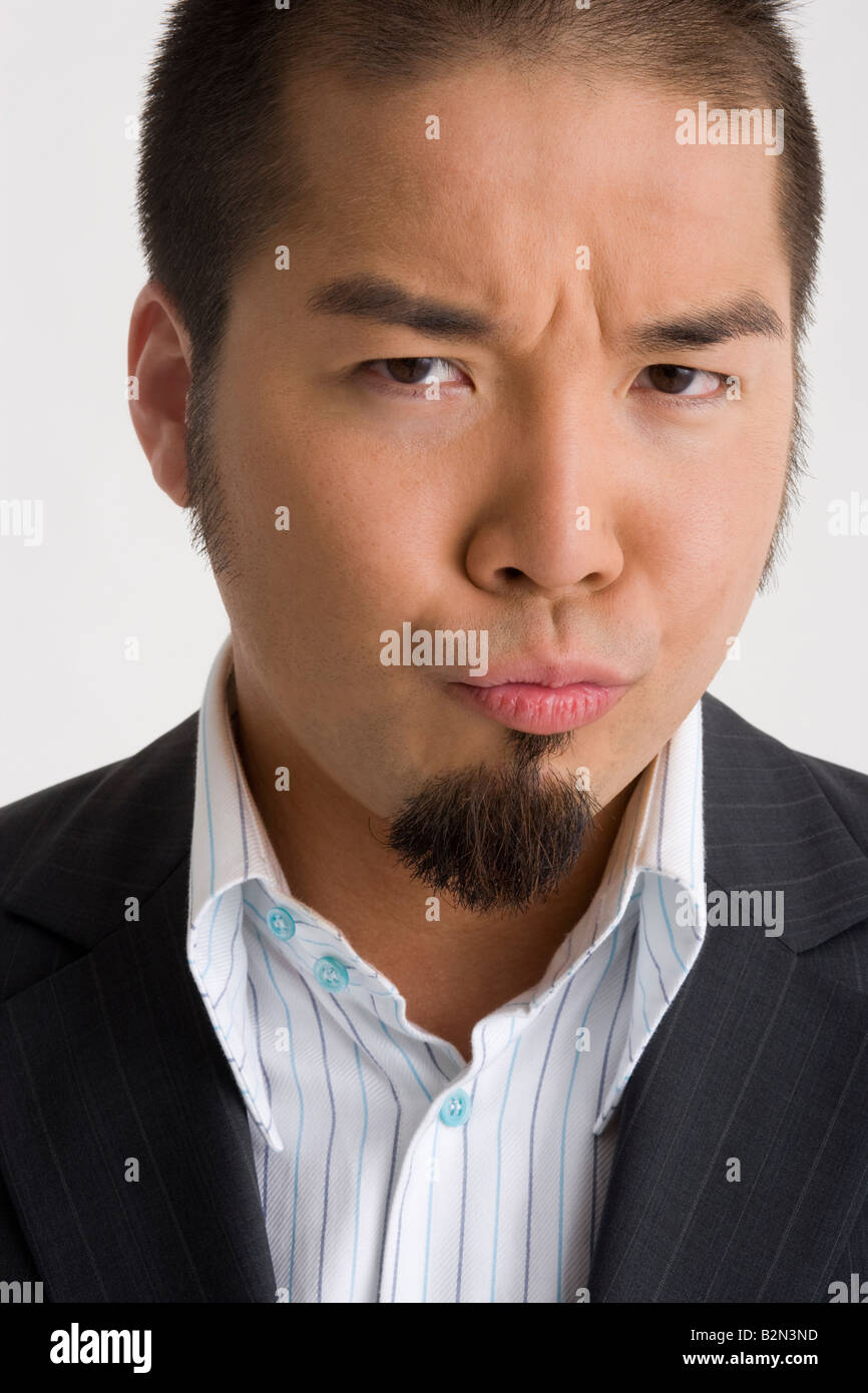 Portrait of a businessman puckering Stock Photo - Alamy