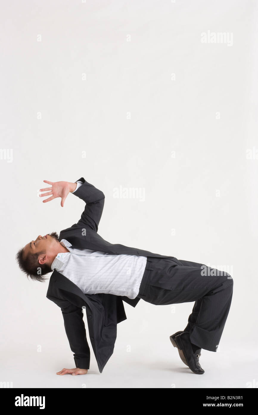 Side profile of a businessman bending over backwards Stock Photo - Alamy