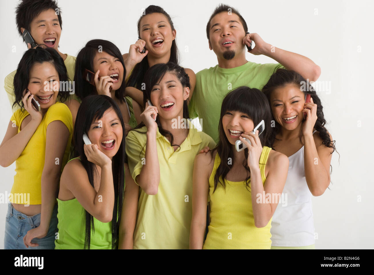 Group of friends talking on mobile phones Stock Photo - Alamy