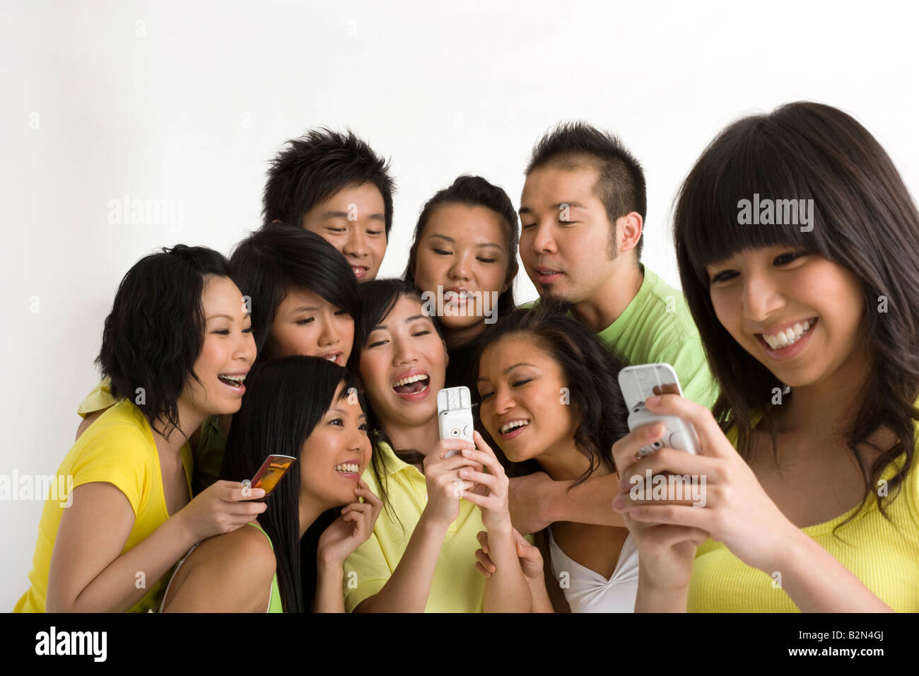 Group of friends text messaging Stock Photo - Alamy