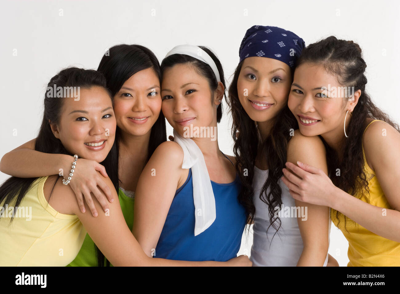 Portrait of five young women hugging each other and smiling Stock Photo ...