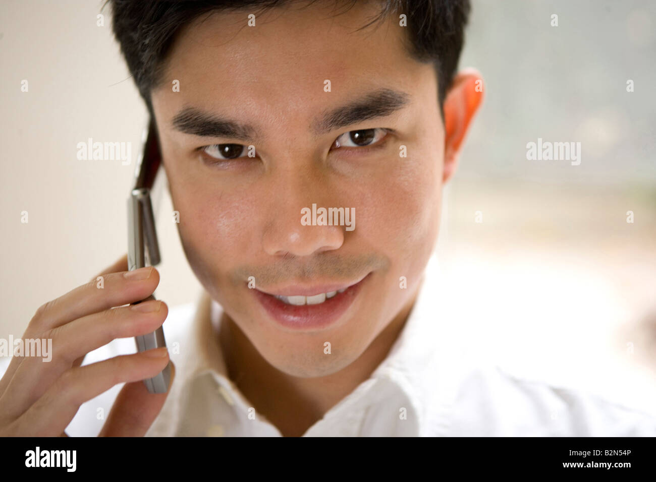 Portrait of a young man using a mobile phone Stock Photo - Alamy