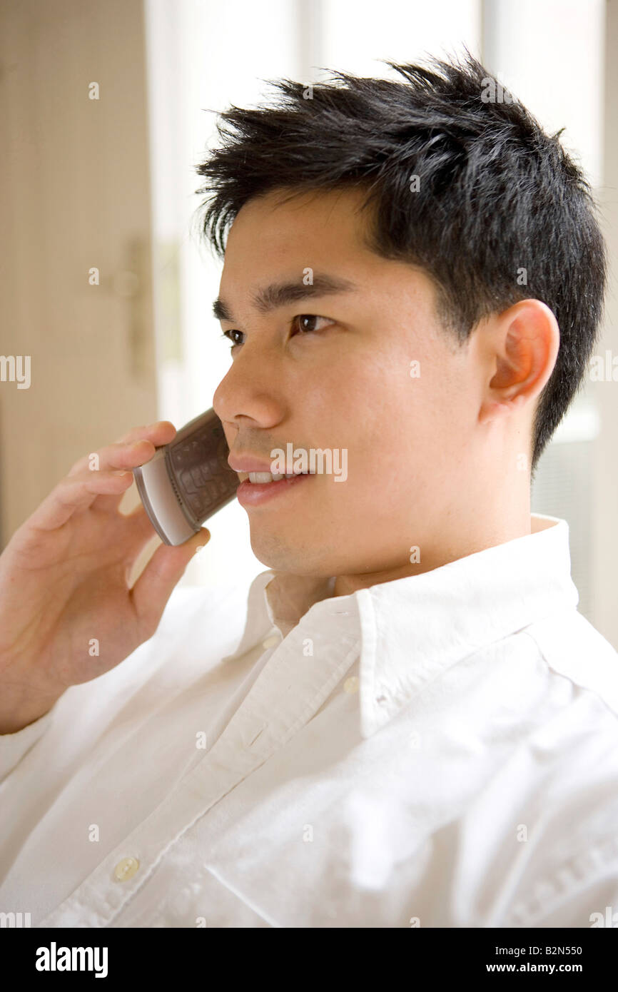 A young man using a mobile phone Stock Photo - Alamy
