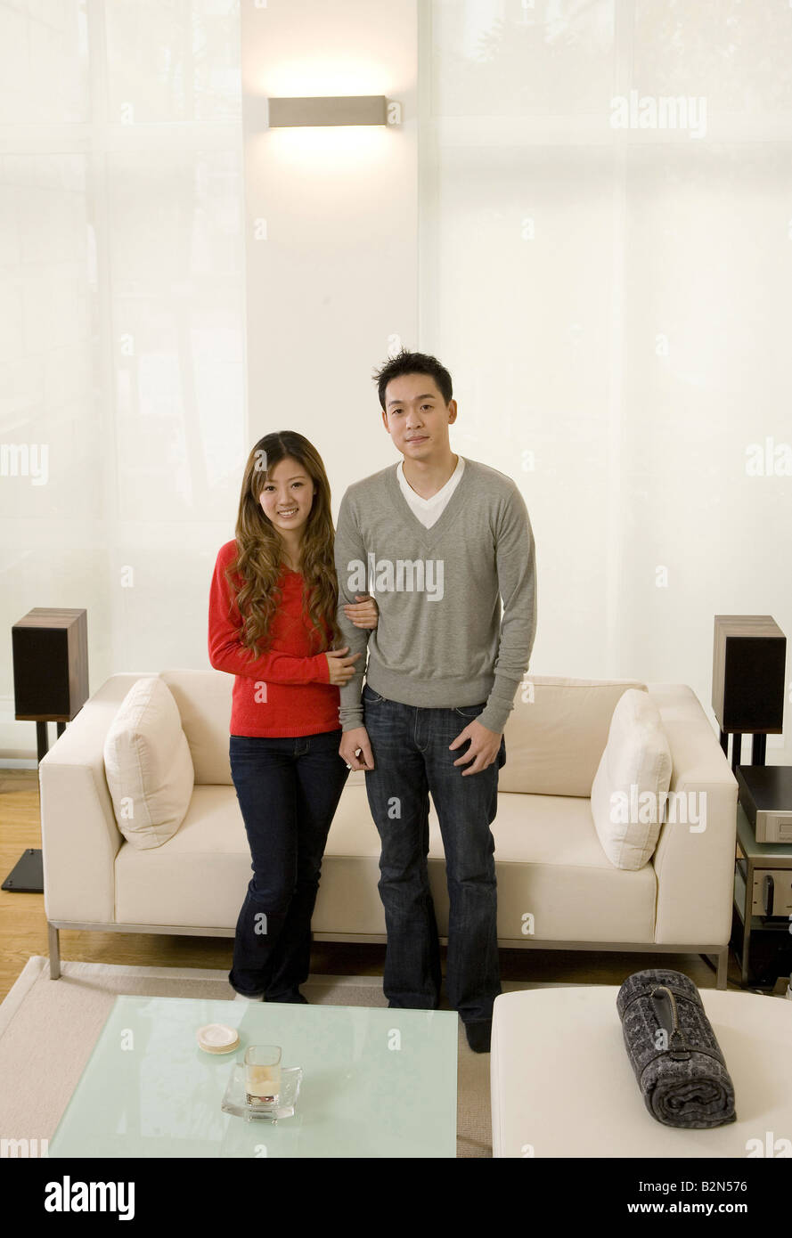 Portrait of a young couple in living room Stock Photo - Alamy