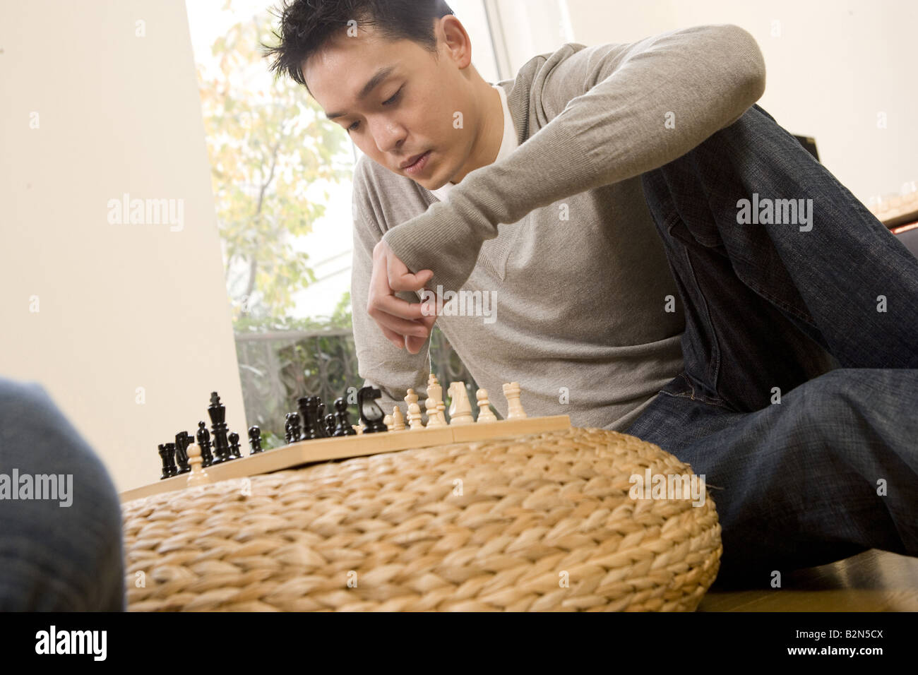 View of a young man playing chess Stock Photo - Alamy