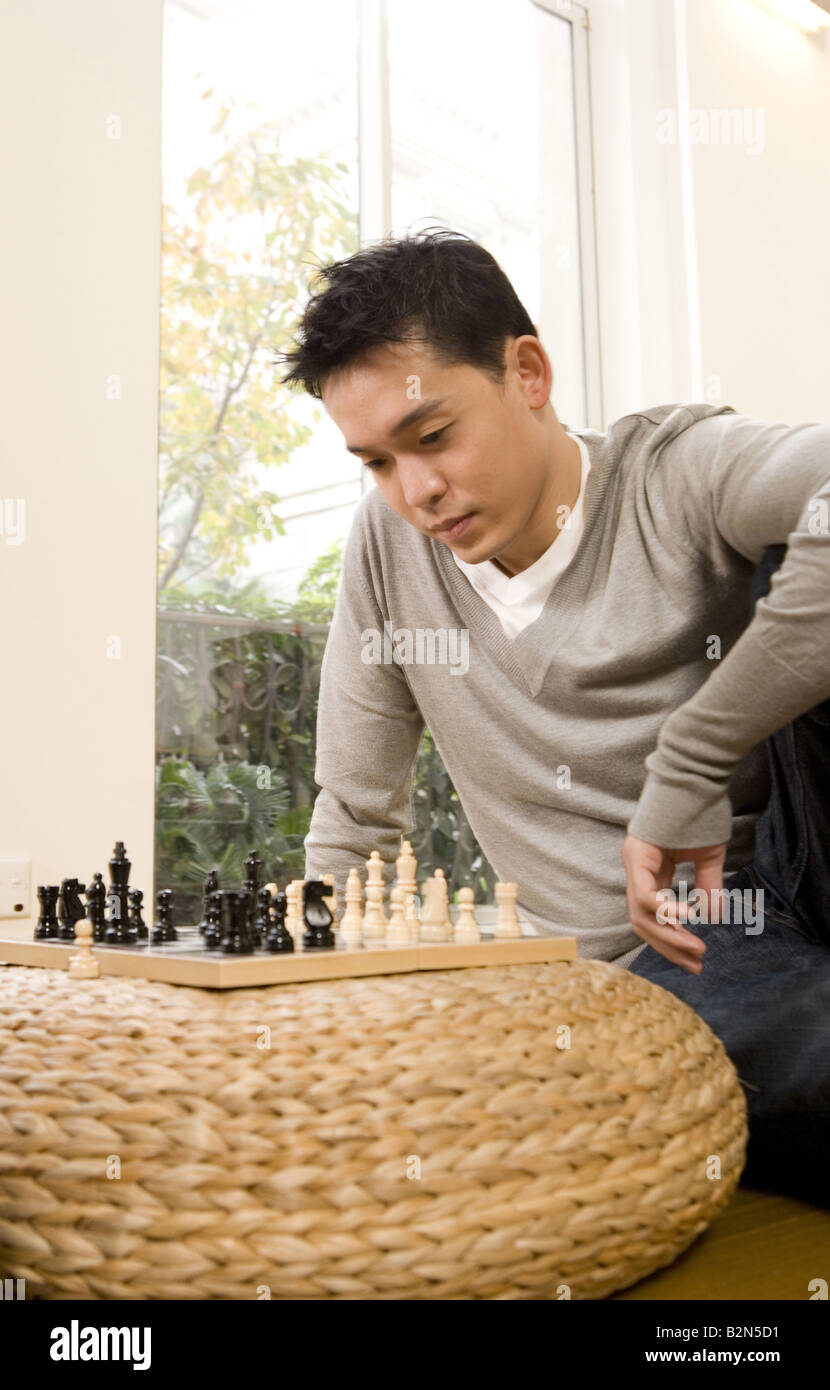 View of a young man playing chess Stock Photo - Alamy