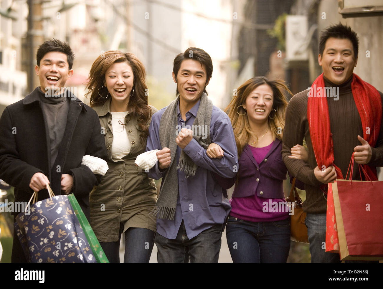 Portrait of friends walking together in a row Stock Photo - Alamy