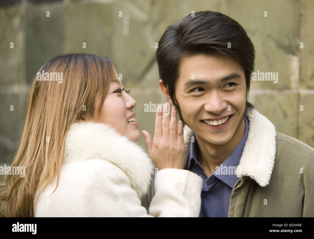 Woman whispering in mans ear hi-res stock photography and images - Alamy