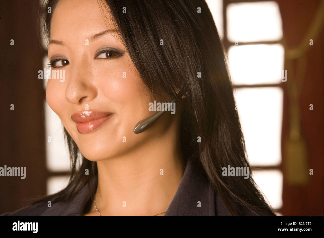 Portrait of a female customer service representative wearing a headset ...