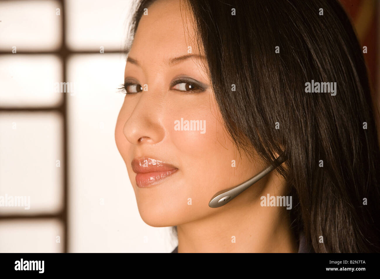 Portrait of a female customer service representative wearing a headset ...