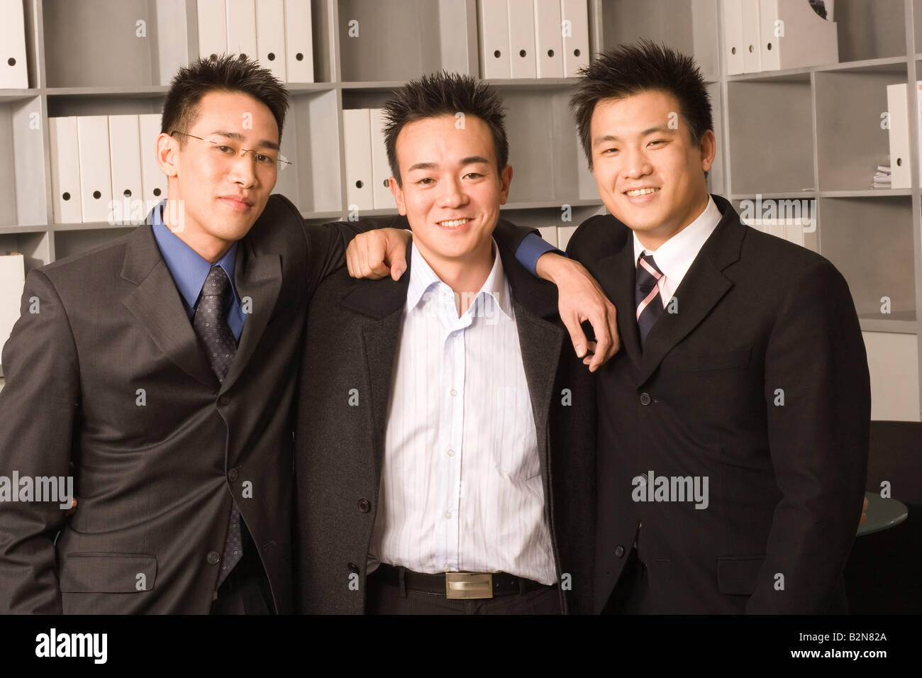 Portrait of three businessmen standing in an office Stock Photo - Alamy