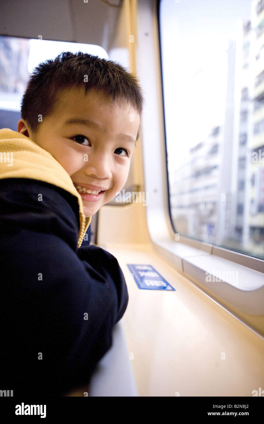 Close-up of a boy smiling in a passenger train Stock Photo - Alamy